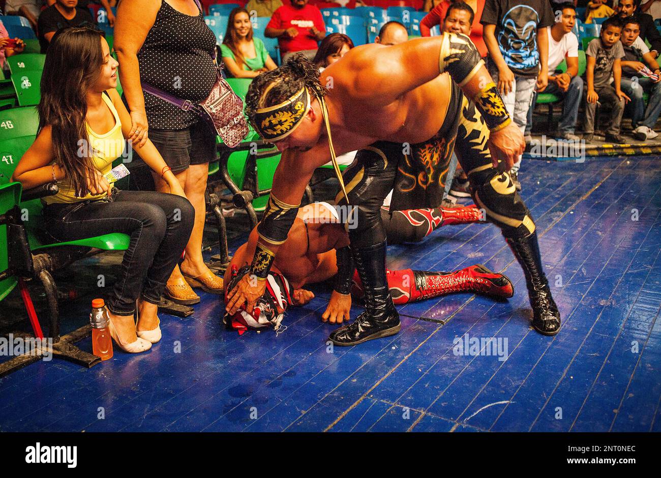 wrestlers outside the ring. Wrestlers perform in a Lucha Libre event in ...