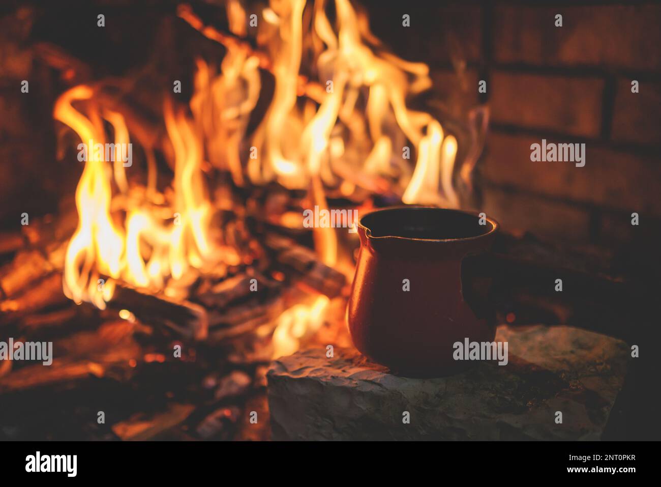 Warming up the fire, cozy winter night in the scandinavian cottage ...
