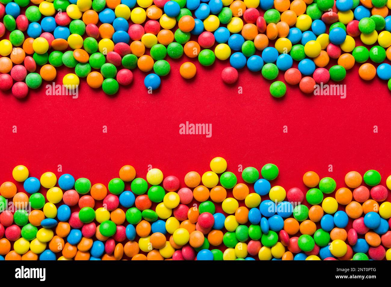 Mixed collection of colorful candy, on colored background. Flat lay ...