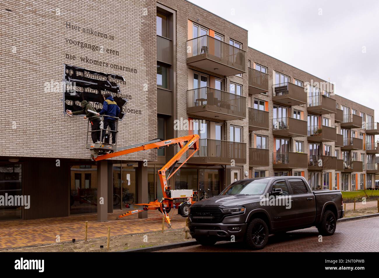 Public community art being implemented and applied to an exterior ...