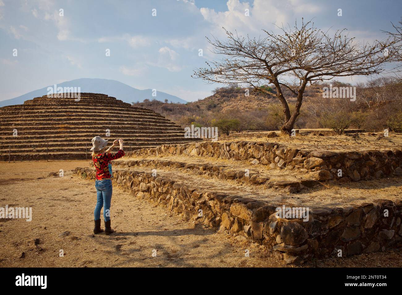Tourist, in background circular stepped pyramid, Guachimontones ...
