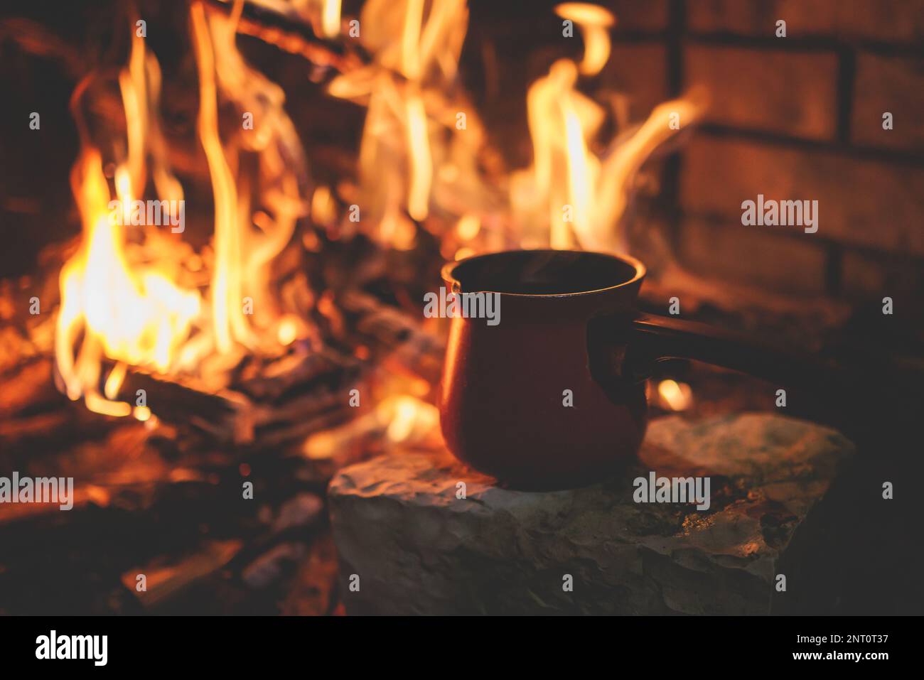 Warming up the fire, cozy winter night in the scandinavian cottage ...