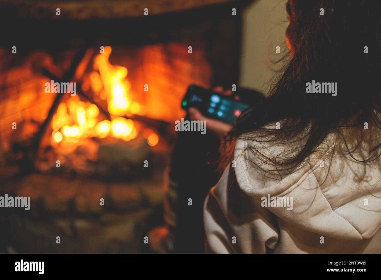 Warming up the fire, cozy winter night in the cabin house by the ...