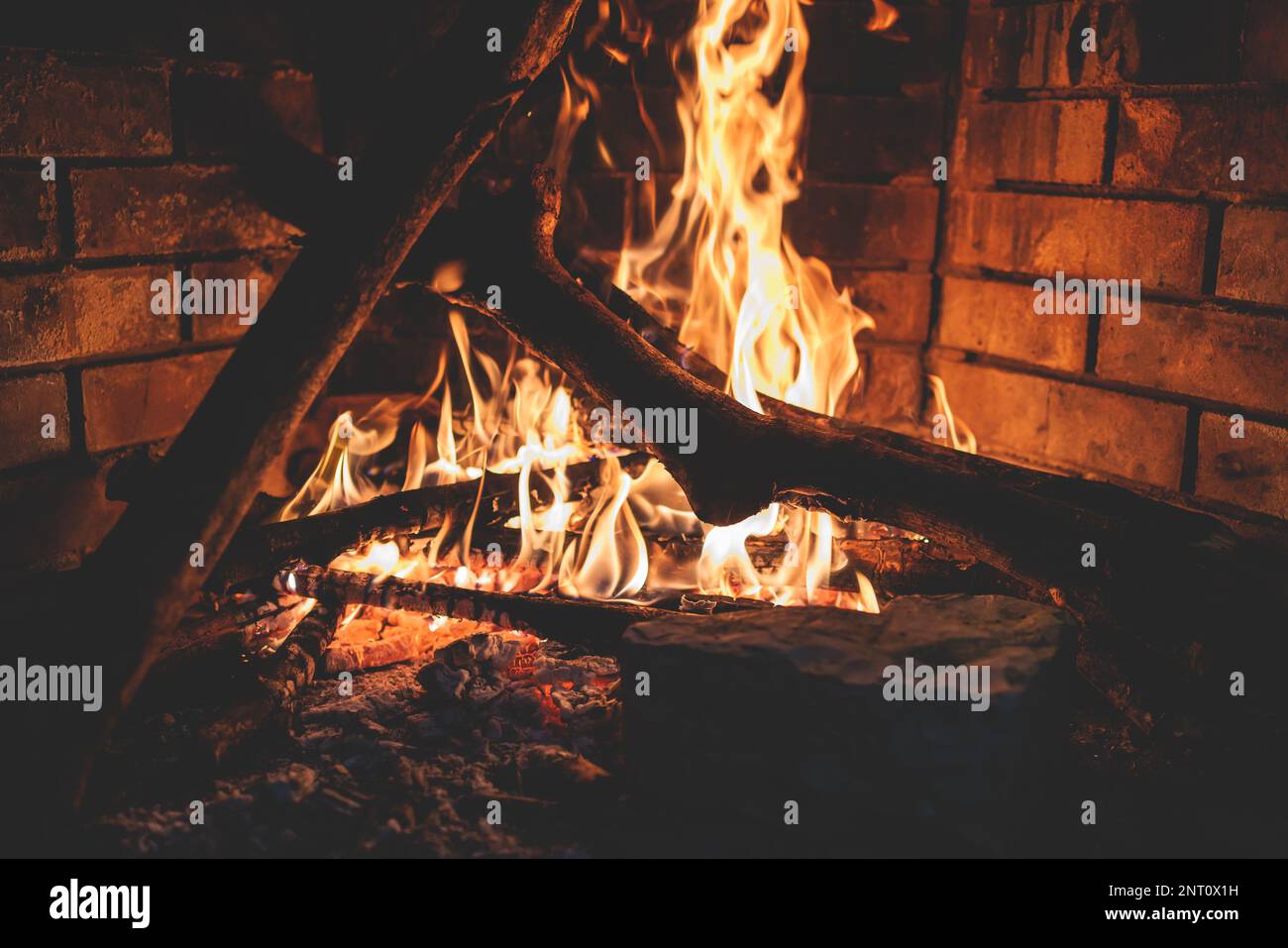 Warming up by the fire, cozy winter night in the cabin by the fireplace ...