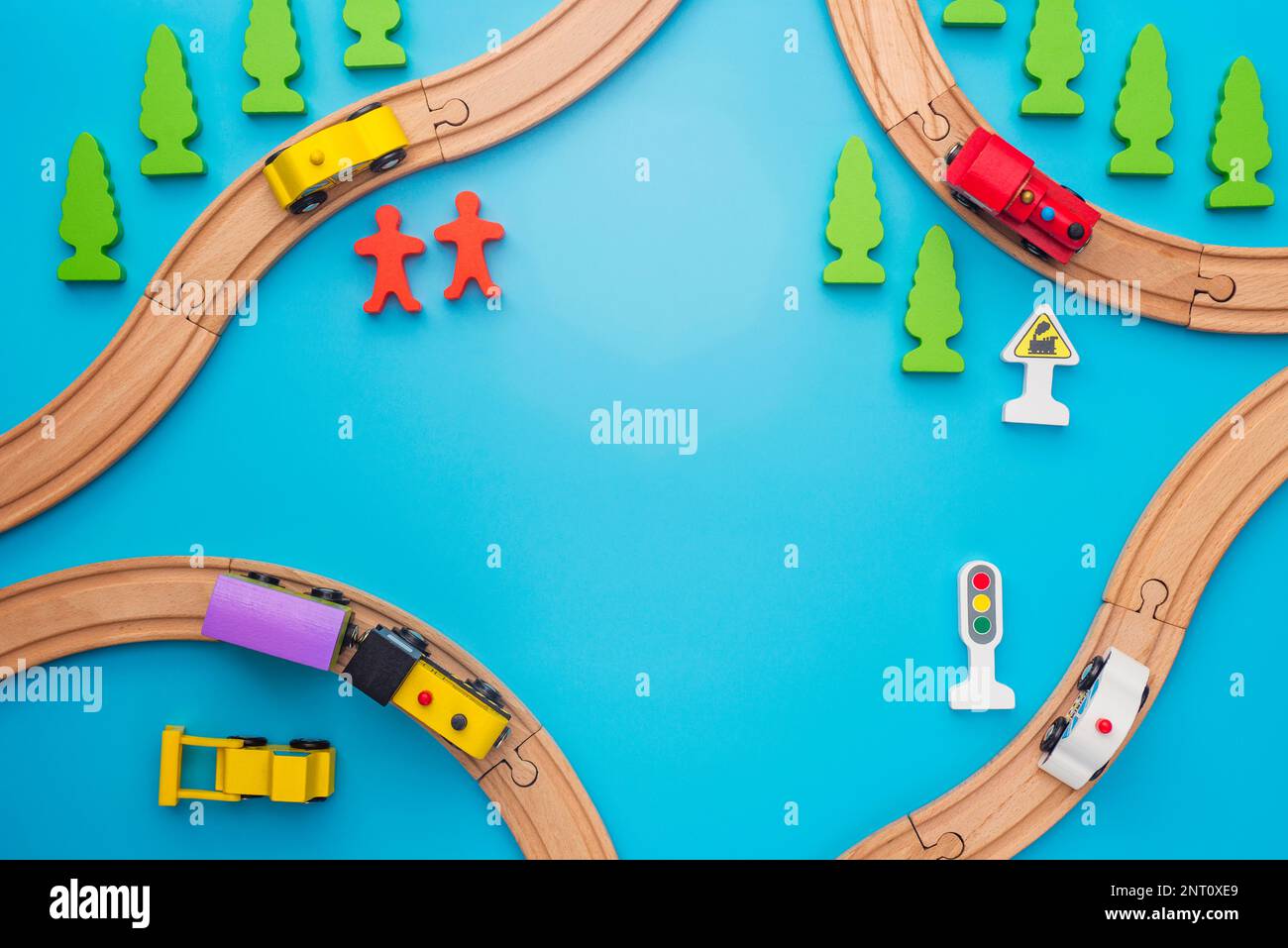 Baby kid toys background. Toy train and wooden rails on blue background Stock Photo - Alamy