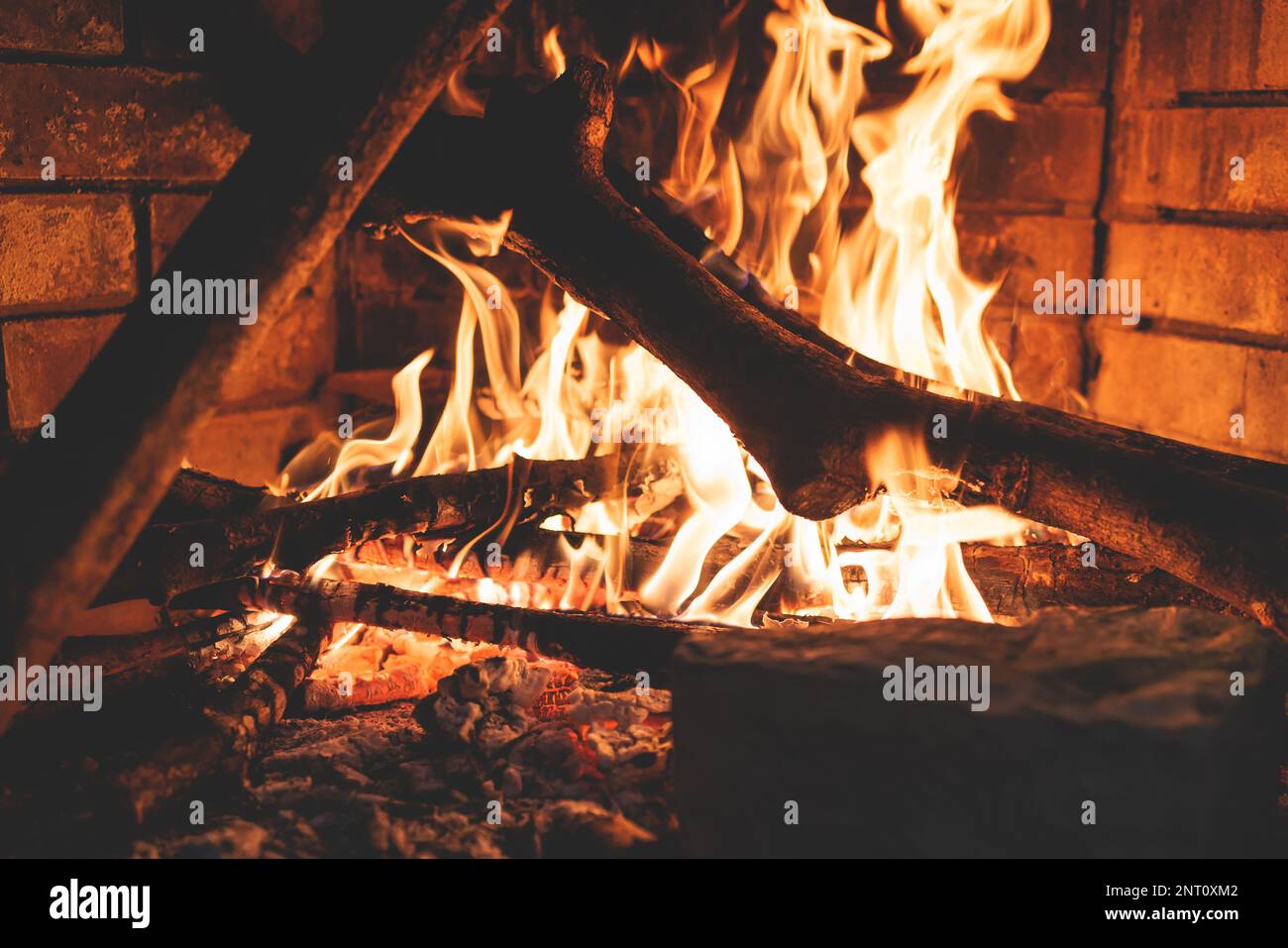 Warming up by the fire, cozy winter night in the cabin by the fireplace ...