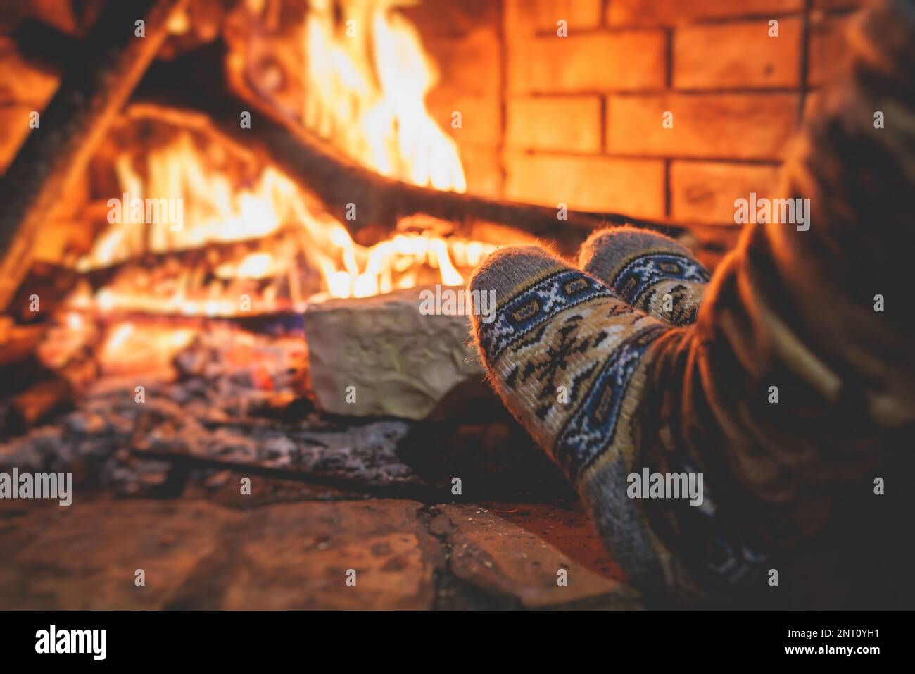 Warming up the fire, cozy winter night in the cabin house by the ...