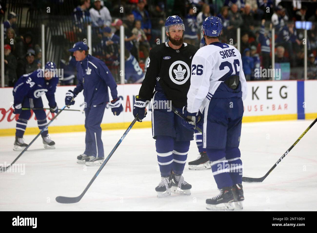 Toronto Maple Leafs' Jake Muzzin and Nick Shore talk on the ice during ...