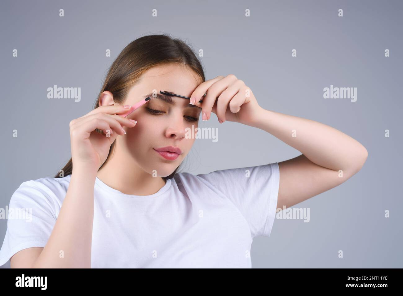 Beautiful woman with dark eyebrows hold eyebrow brush. Eyebrows ...
