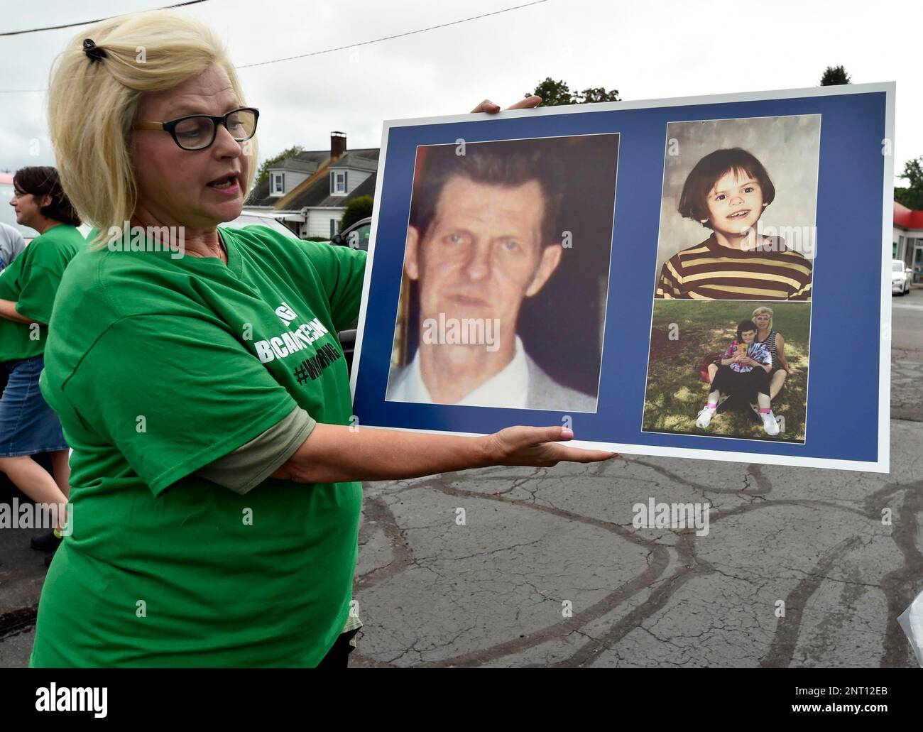 Ann Winsock holds photos of her father and sister Janine Winsock who ...