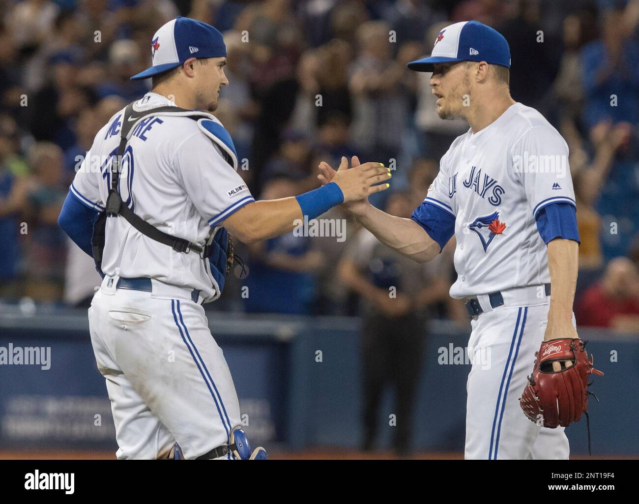 Toronto Blue Jays catcher Reese McGuire (10) congratulates relief ...