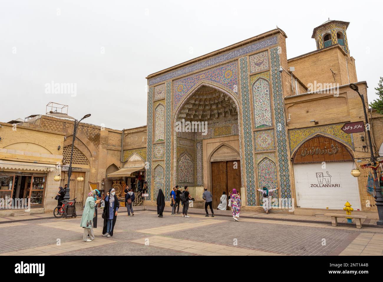 An archway decorated with tile mosaics marks the main entrance to Vakil ...
