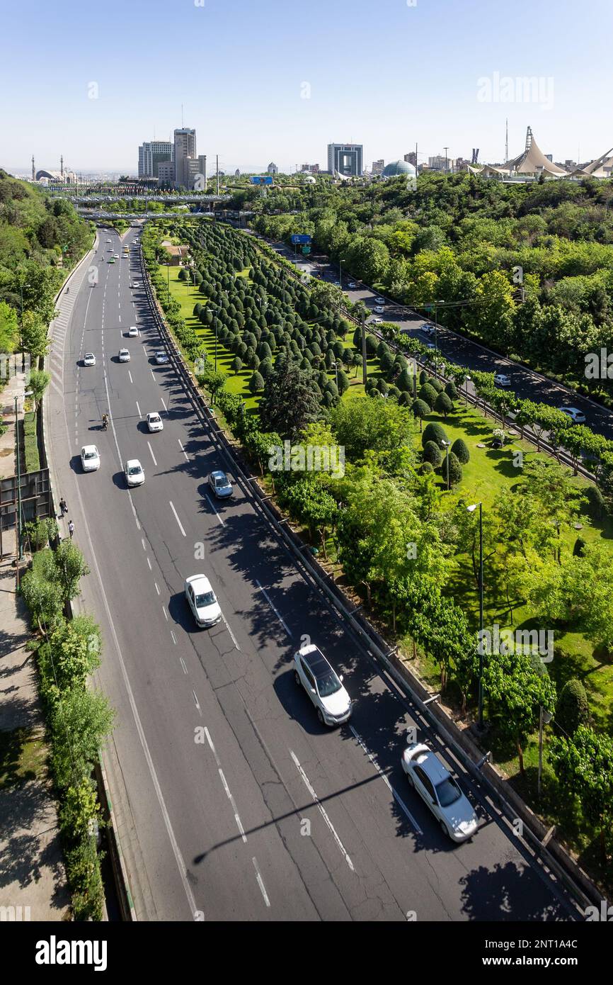 Leafy manicured parks surround a highway running through central Tehran ...
