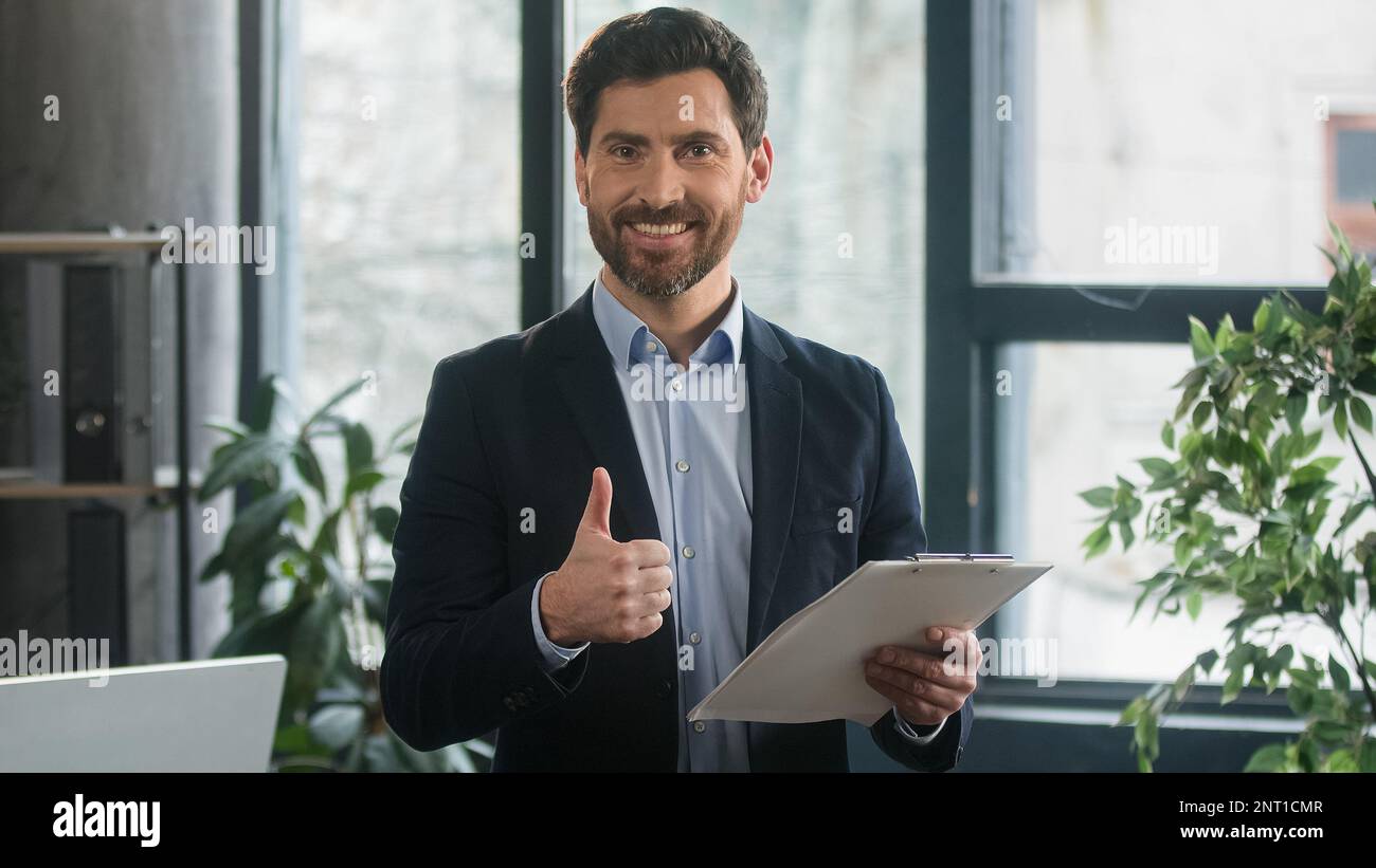 Focused adult caucasian man recruiting agent standing in office making ...
