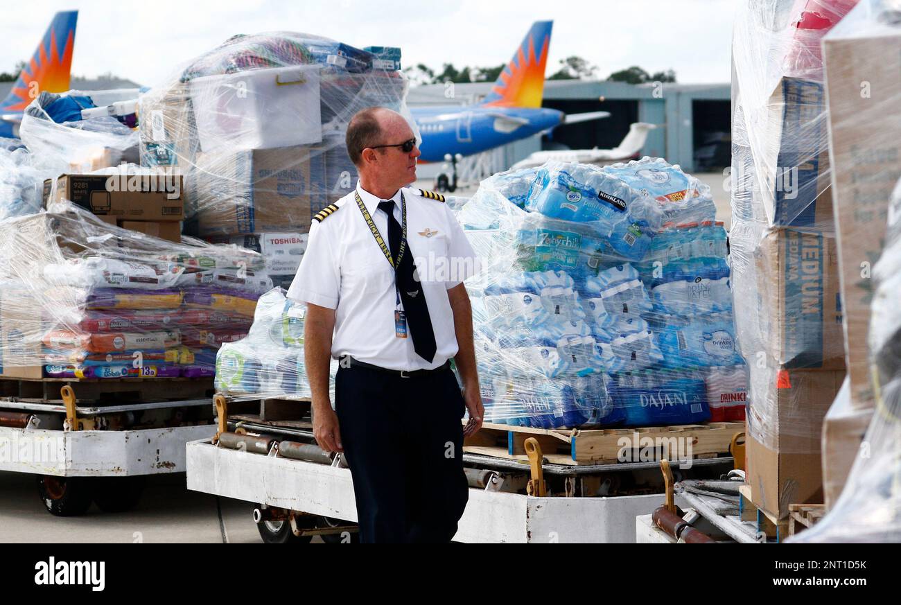 Allegiant captain Anthony Armstrong inspects the cargo prior to it ...
