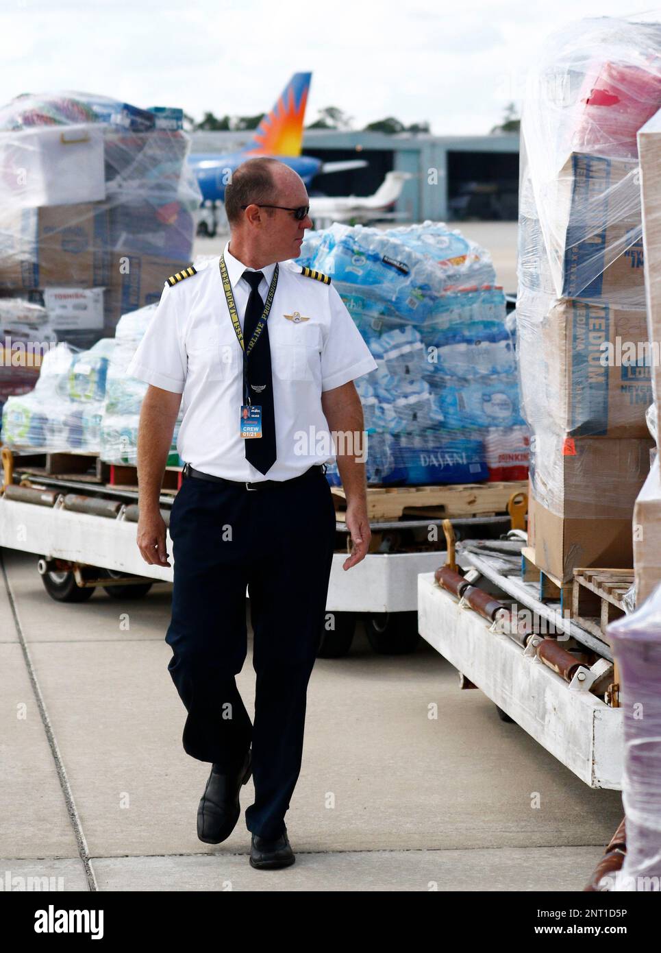Allegiant captain Anthony Armstrong inspects the cargo prior to it ...