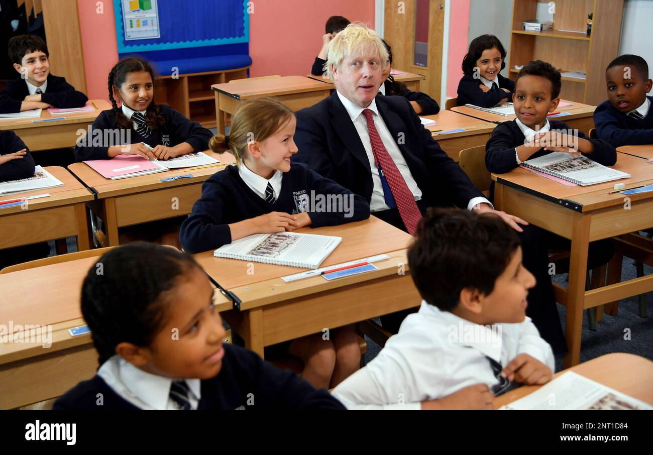 Britain's Prime Minister Boris Johnson, center, visits Pimlico Primary school in London, Tuesday ...