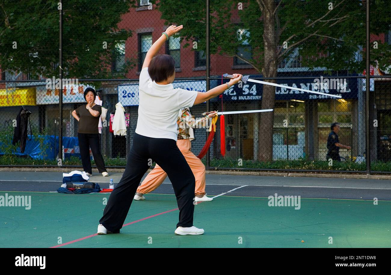 Chinese people performing early morning Sword exercises in Columbus ...