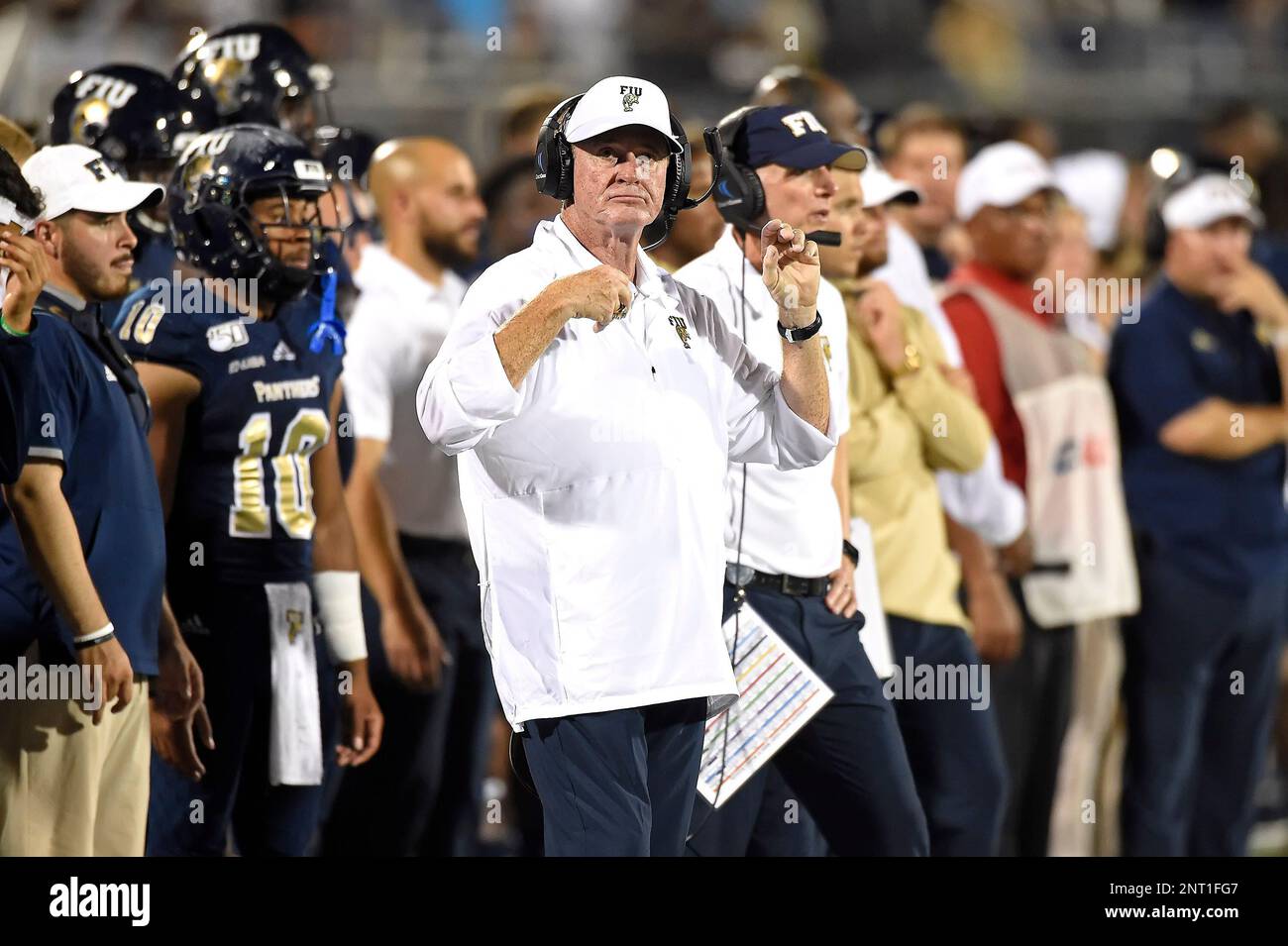 MIAMI, FL - SEPTEMBER 07: FIU Football Head Coach Butch Davis checks ...