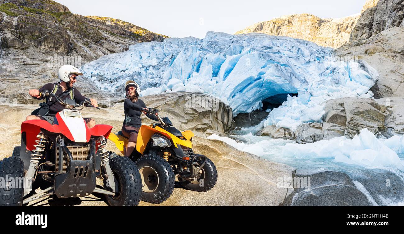 ATV Quad driving people - happy smiling couple in front of Glacier ...