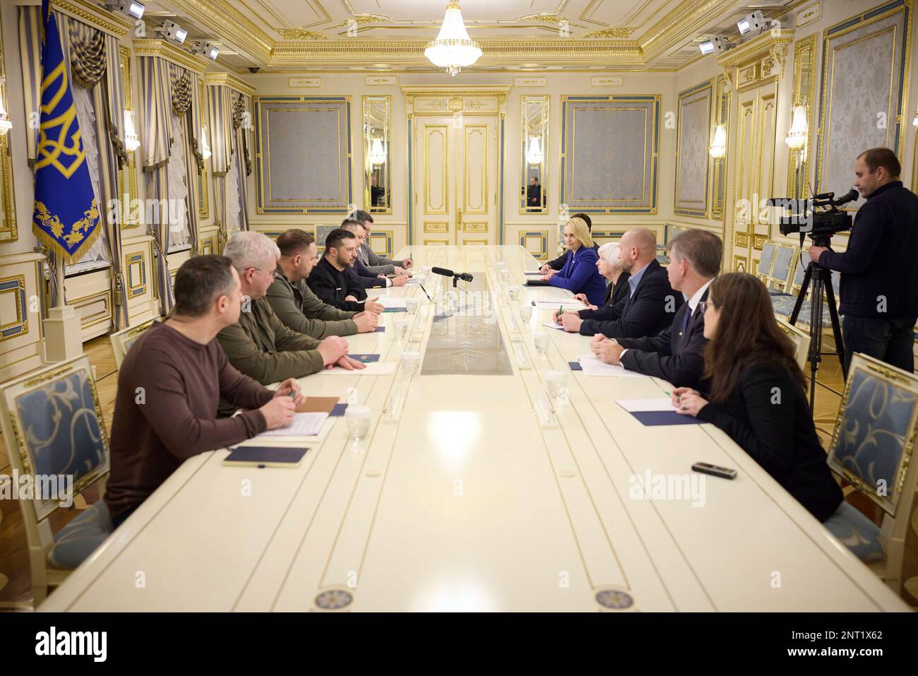 Kyiv, Ukraine. 27th Feb, 2023. Ukrainian President Volodymyr Zelenskyy, left, delivers remarks ...