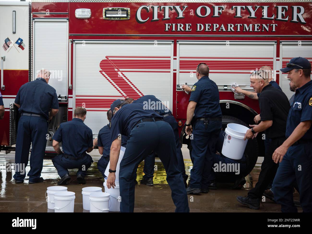 Firefighters give a ceremonial wash to their new engine at the City of ...