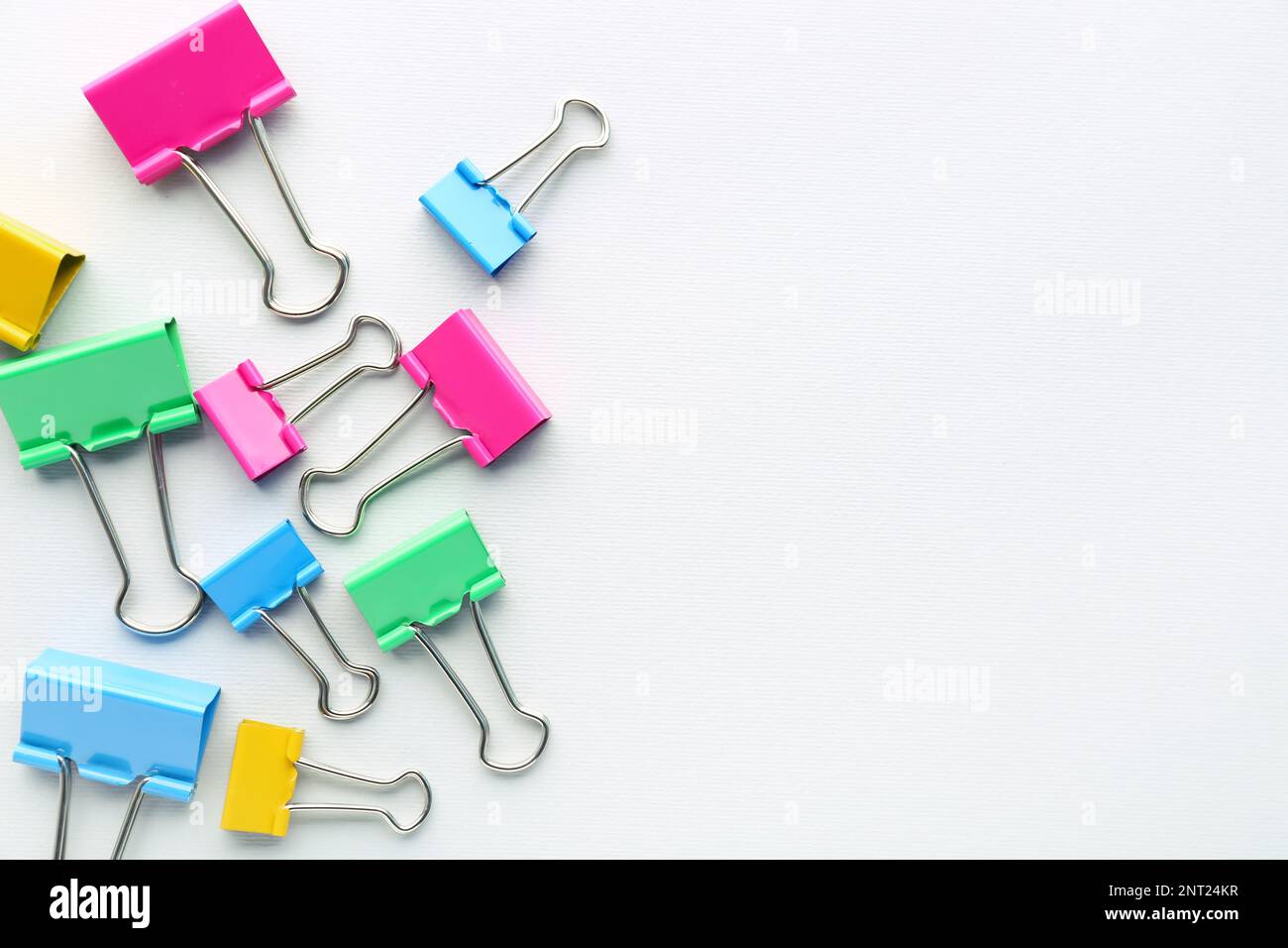 Colorful binder clips on grey background Stock Photo - Alamy