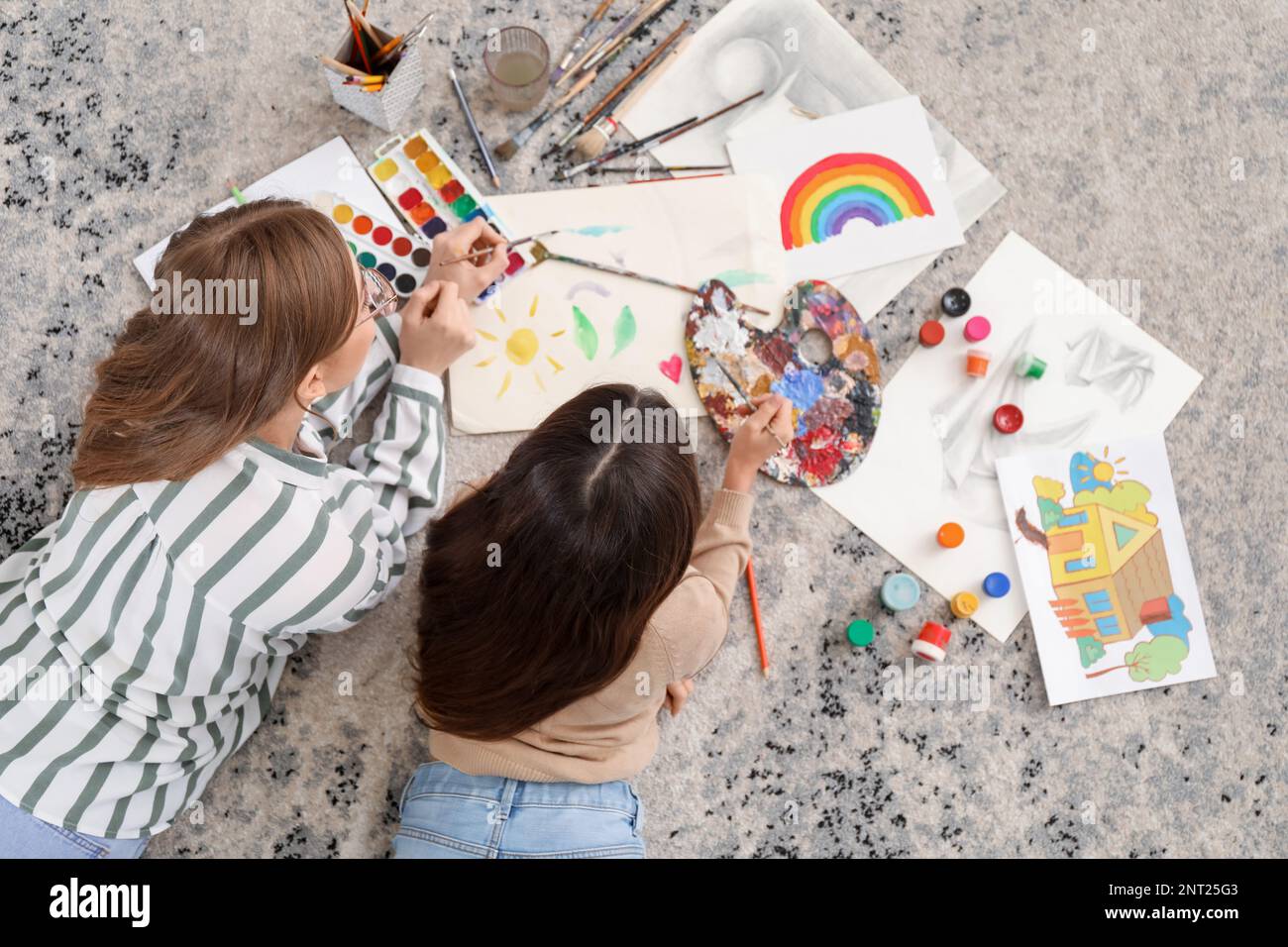 Drawing teacher giving private art lesson to little girl at home, top ...