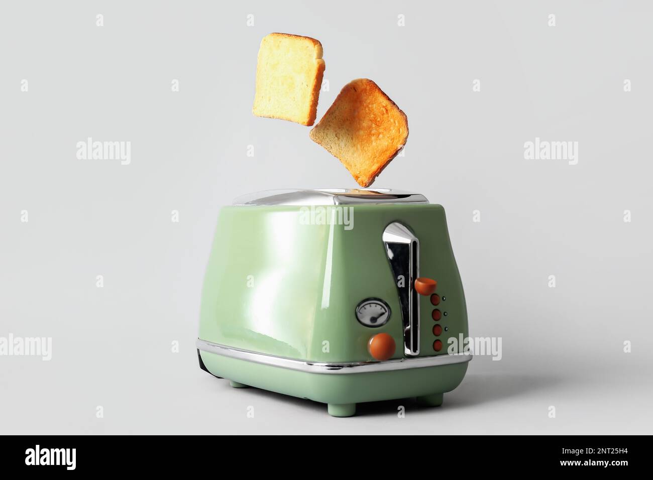 Modern toaster with crispy bread slices on grey background Stock Photo - Alamy