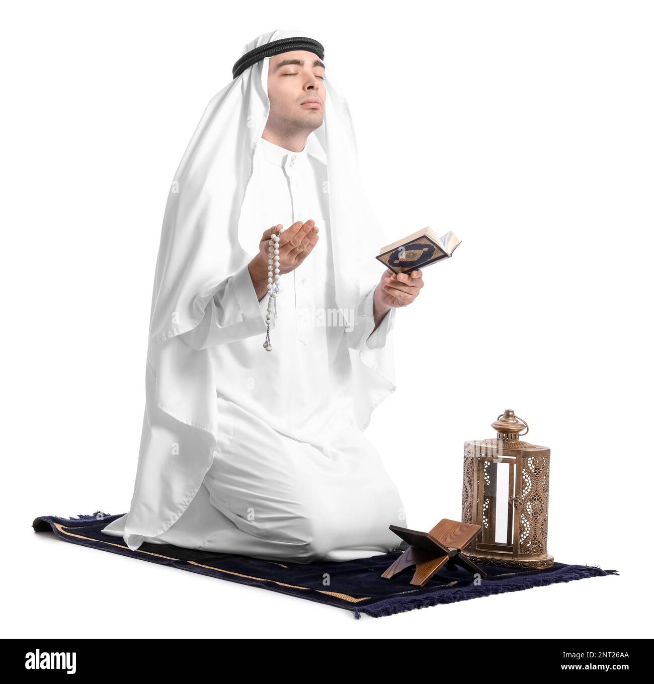 Praying Muslim man with Koran on white background Stock Photo - Alamy