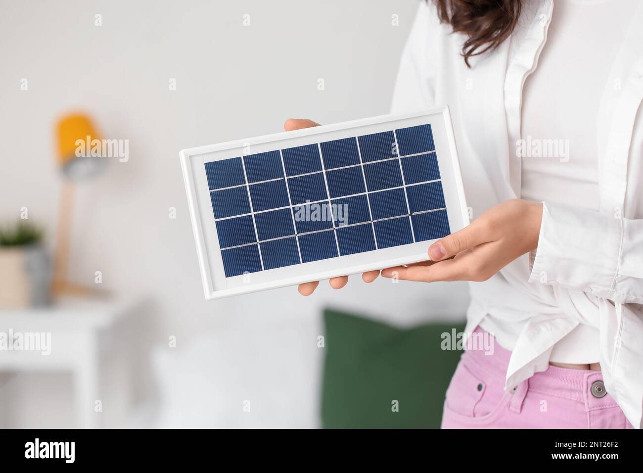 Teenage girl with portable solar panel in bedroom, closeup Stock Photo ...