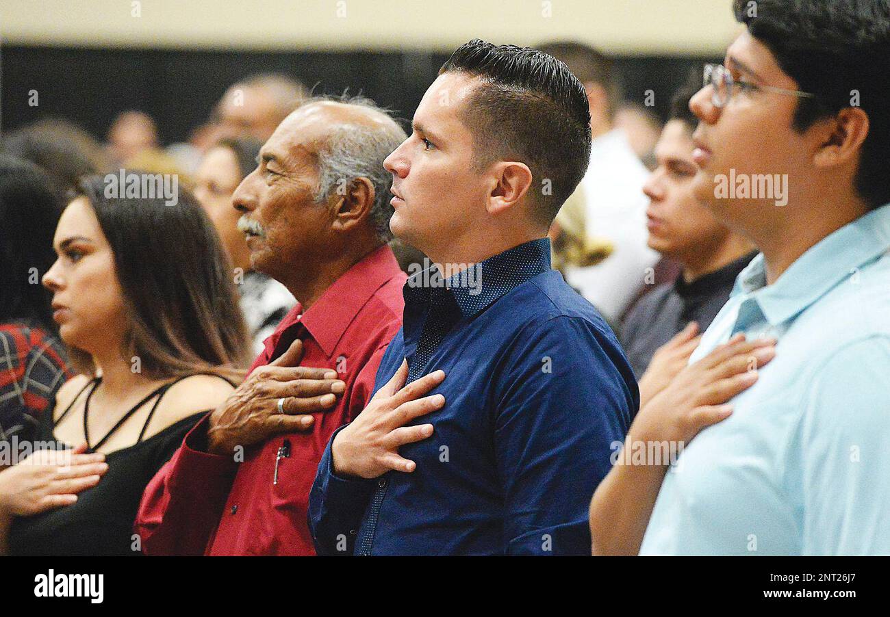 With their hands over their hearts, applicants for U.S. citizenship ...