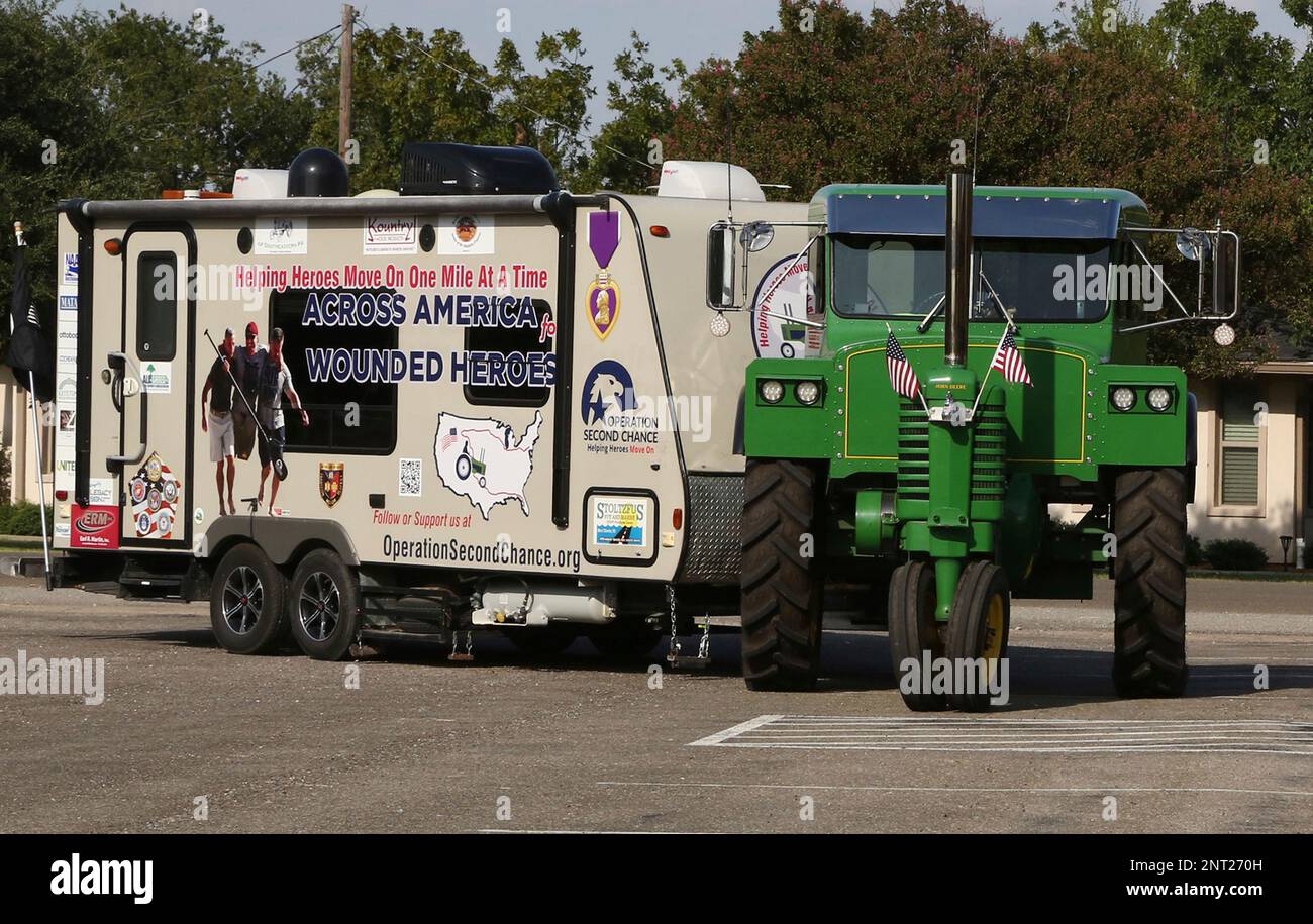C. Ivan Stoltzfus walks past his 1948 John Deere Model A tractor pulls ...