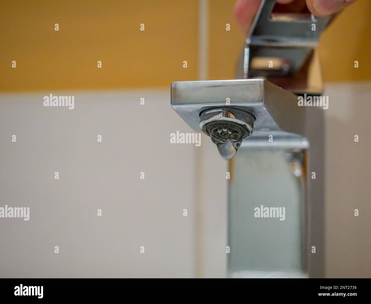 Running water from a square faucet in a modern bathroom Stock Photo - Alamy