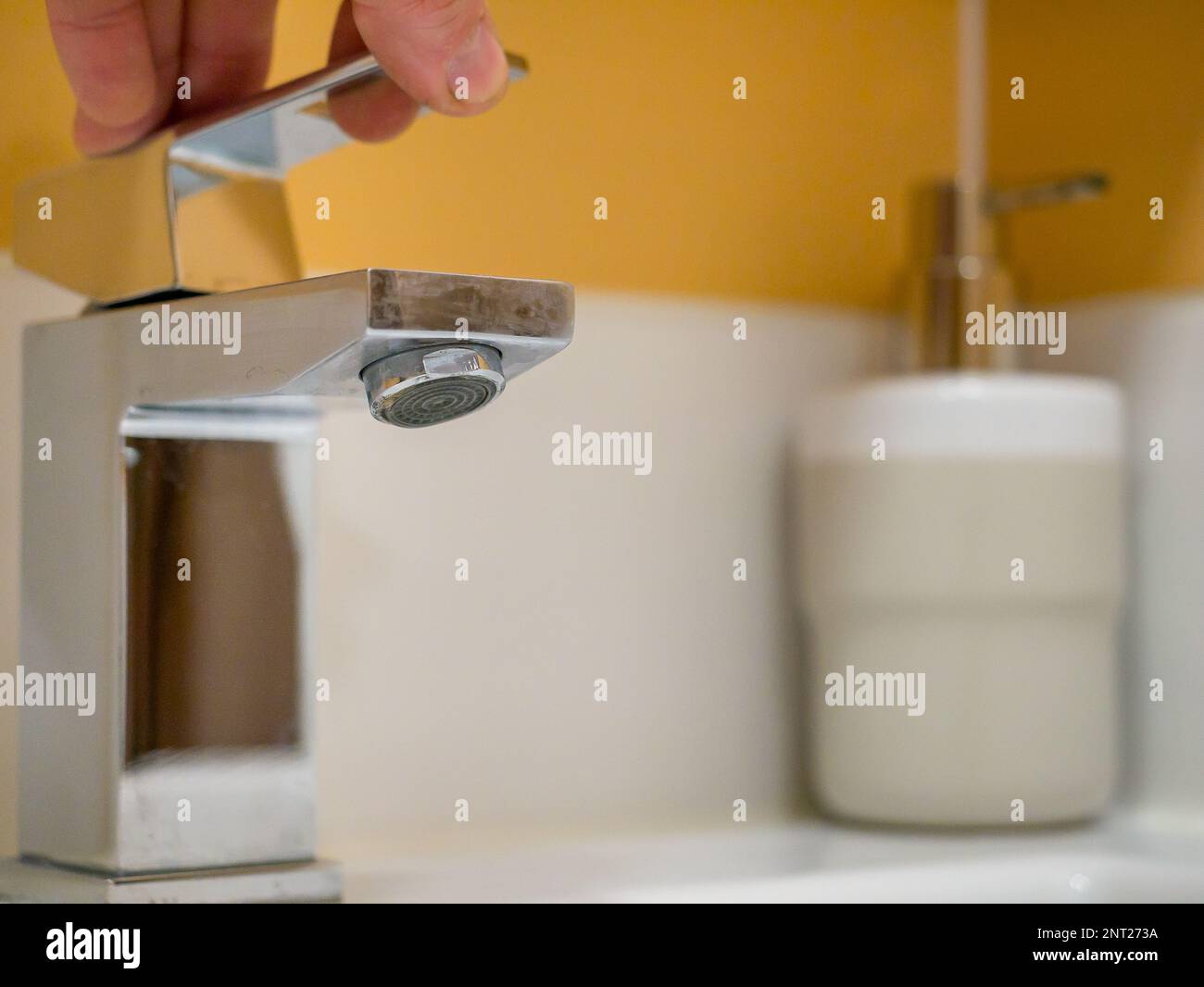 Running water from a square faucet in a modern bathroom Stock Photo - Alamy
