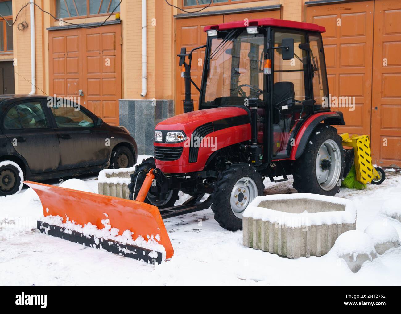 Red snowblower grader on snow covered road in city street. Winter ...