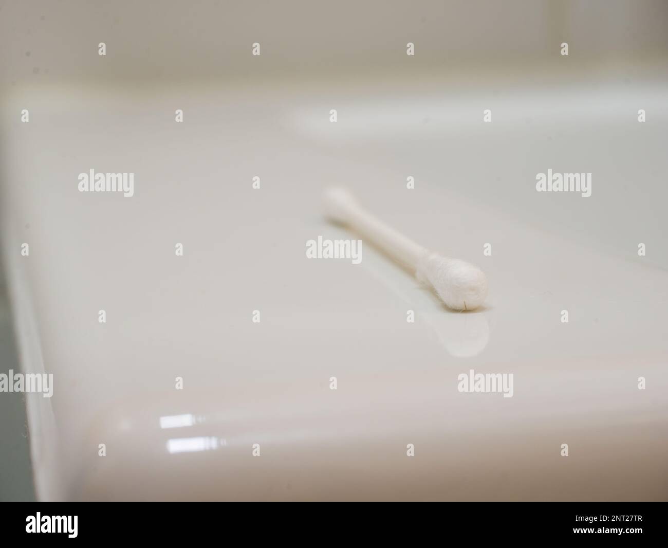 Cotton swabs in the ears on a white background Stock Photo - Alamy