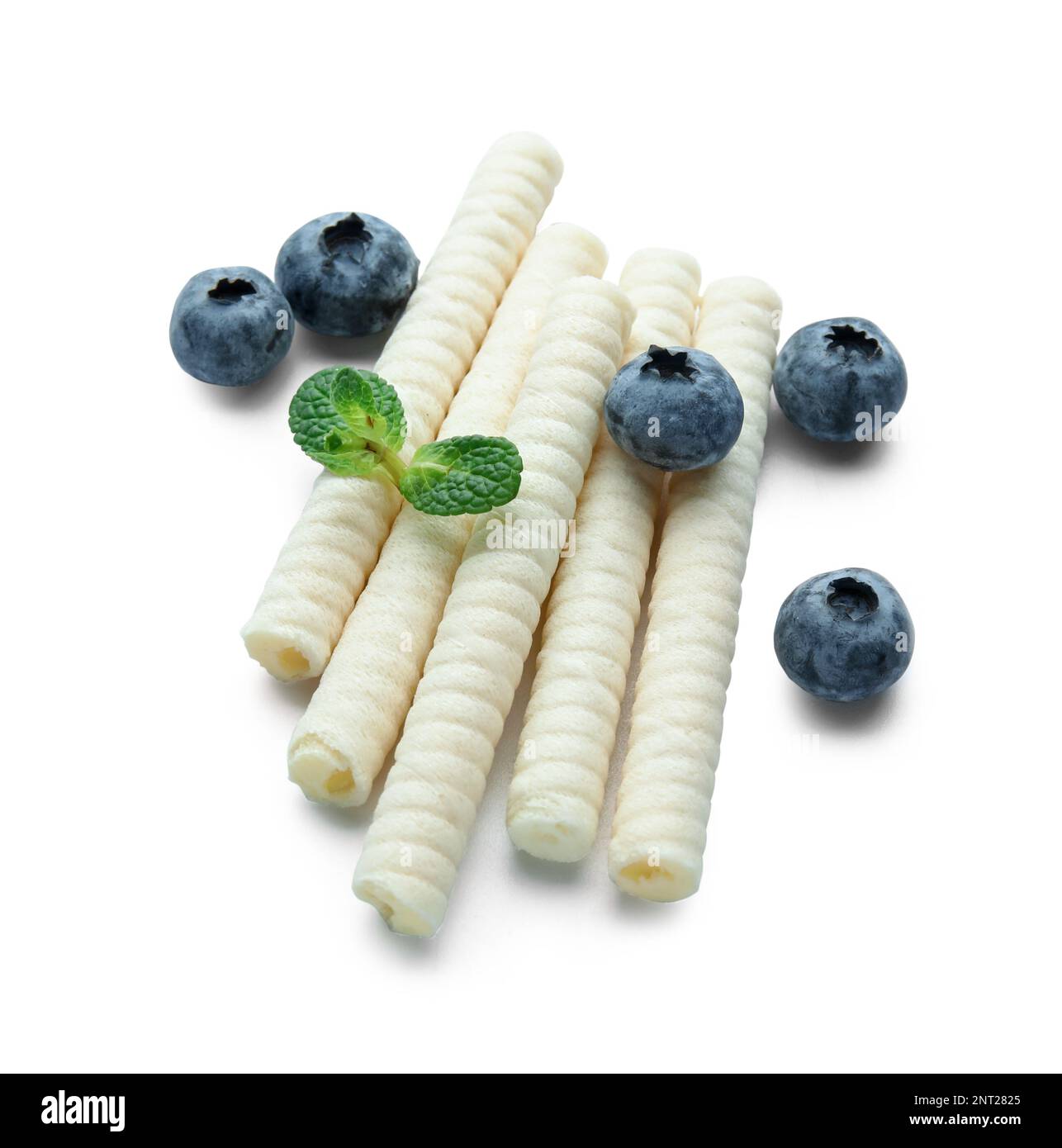 Delicious wafer rolls, blueberries and mint isolated on white ...