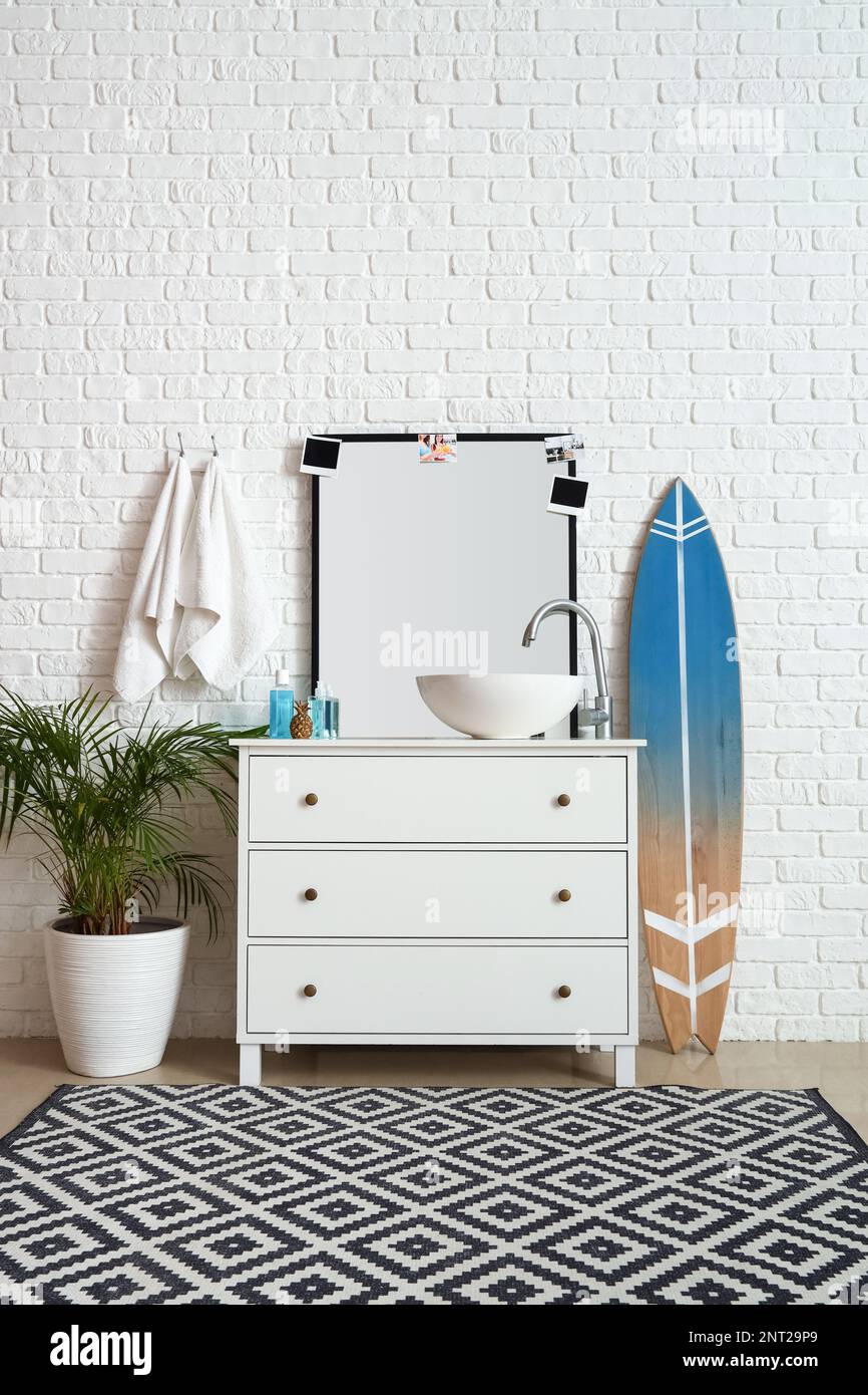 Interior of bathroom with sink, drawers and surfboard Stock Photo - Alamy