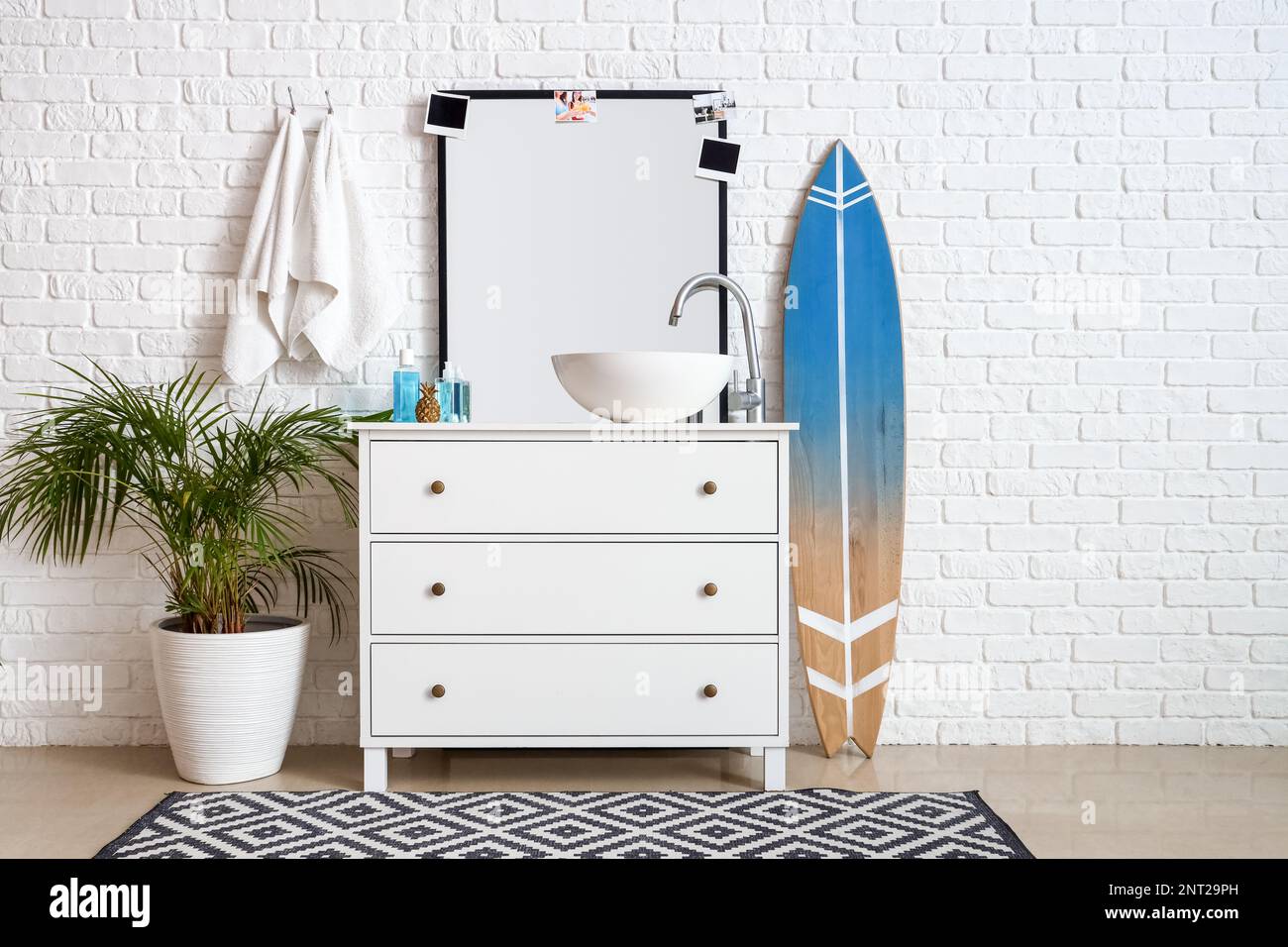 Interior of bathroom with sink, drawers and surfboard Stock Photo - Alamy
