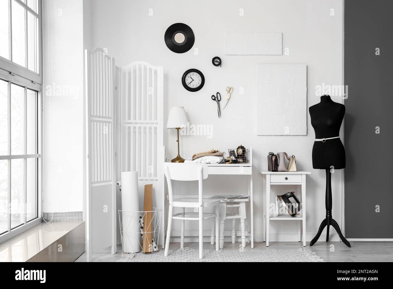 Interior of modern atelier with tailor's workplace and mannequin Stock ...