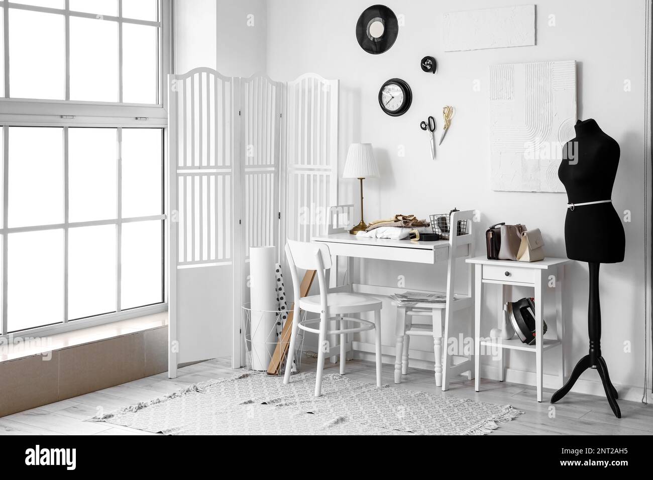 Interior of modern atelier with tailor's workplace and mannequin Stock ...