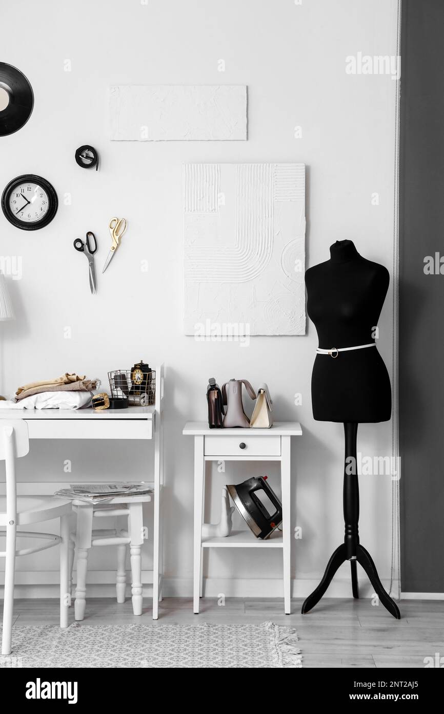 Interior of modern atelier with tailor's workplace and mannequin Stock ...