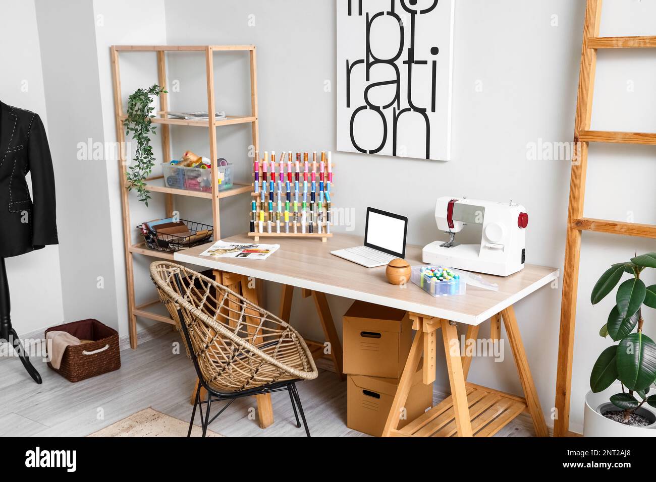 Interior of modern atelier with tailor's workplace and shelving unit ...