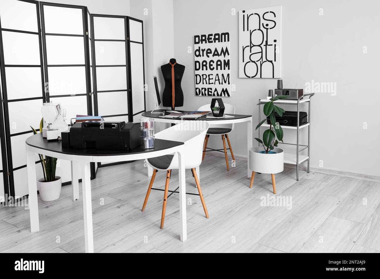 Interior of modern atelier with tables and mannequin Stock Photo - Alamy