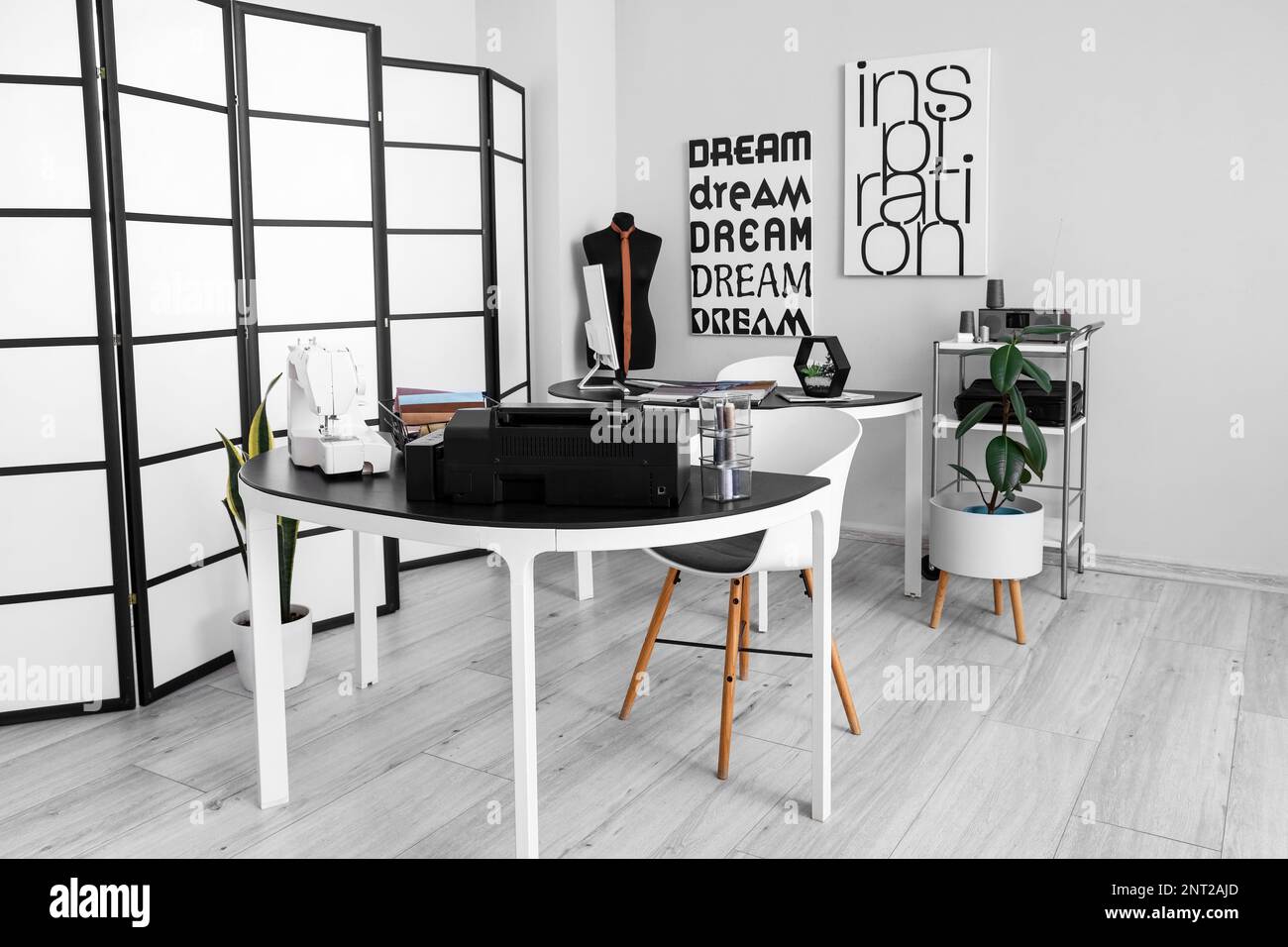 Interior of modern atelier with tables and mannequin Stock Photo - Alamy