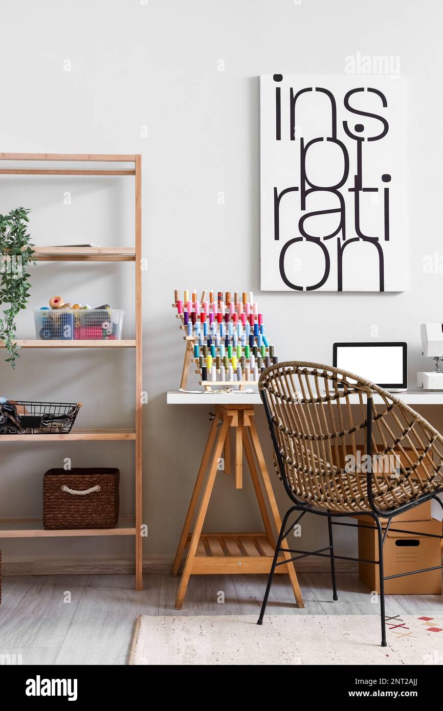 Interior of modern atelier with tailor's workplace and shelving unit ...