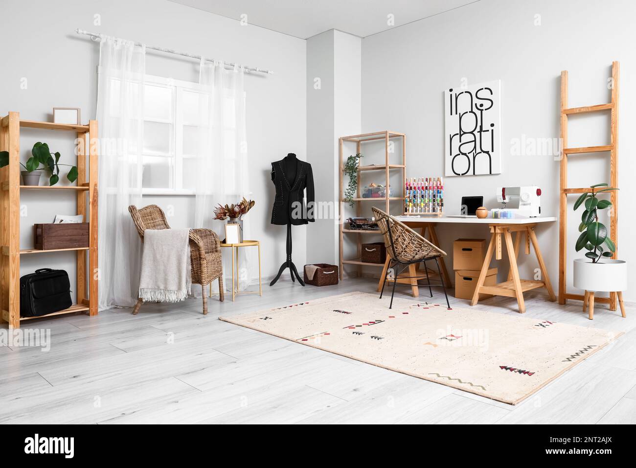 Interior of modern atelier with tailor's workplace, shelving unit and ...