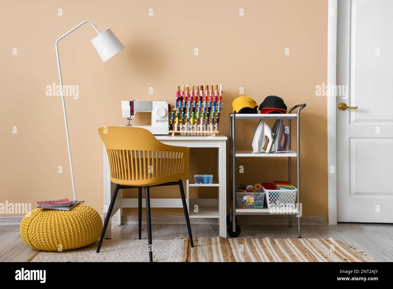 Interior of modern atelier with tailor's workplace and shelving unit ...