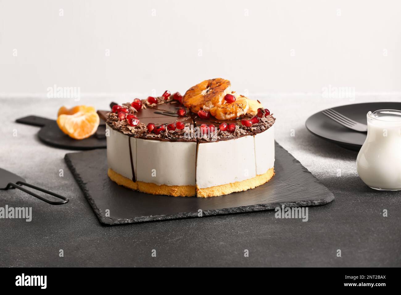 Slate board with delicious birds milk cake on black and white ...